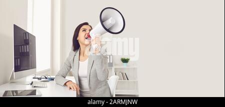 Business woman with megaphone sitting on wooden bench. Female speaker ...