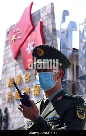 A Chinese paramilitary policeman stands guard after the opening of the ...