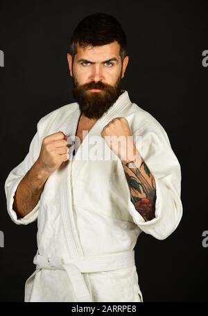 Karate man with angry face in uniform. Man with beard in white kimono ...