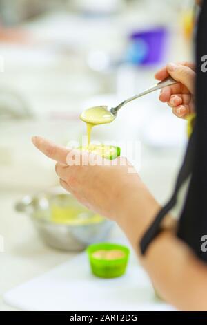 The process of making cupcakes. Creation of cakes by professional ...