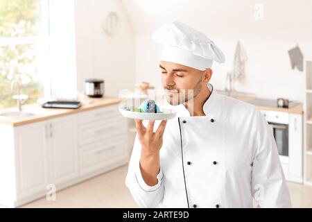 Male confectioner with tasty dessert in kitchen Stock Photo - Alamy