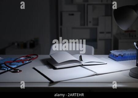 Workplace of doctor late in evening Stock Photo - Alamy