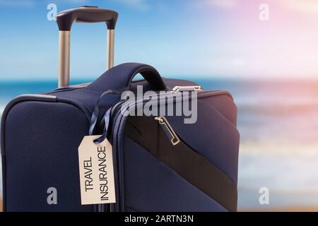 Suitcase with TRAVEL INSURANCE label, closeup Stock Photo - Alamy