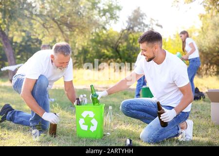 People gathering garbage outdoors. Concept of recycling Stock Photo - Alamy