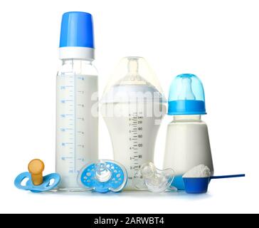 Feeding bottles with milk and pacifiers on white background Stock Photo ...