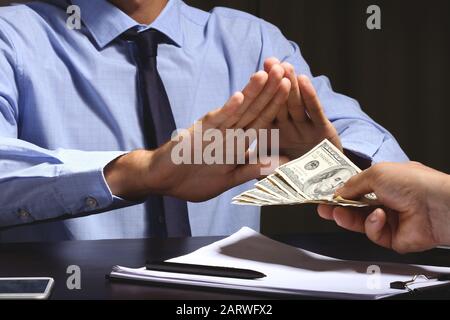 Businessman refusing to take bribe at workplace Stock Photo - Alamy