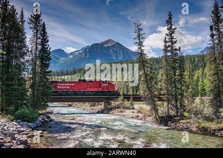 Train and railway with mountain scenery: A Canadian Pacific diesel ...