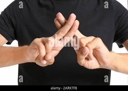 Young deaf mute man using sign language on light background Stock Photo ...