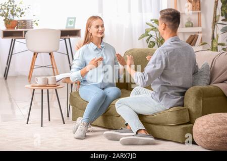 Young deaf mute couple using sign language at home Stock Photo - Alamy