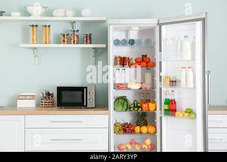 Open big fridge with fresh products in kitchen Stock Photo - Alamy