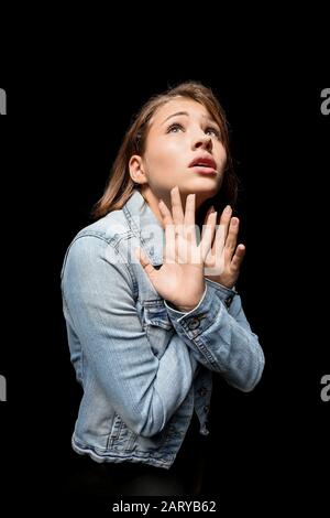 Afraid teenage girl on dark background Stock Photo - Alamy