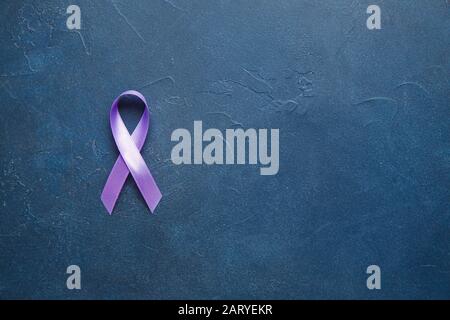 Lilac ribbon on color background. Cancer awareness concept Stock Photo ...