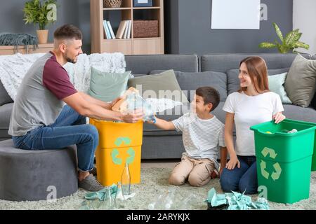 Family sorting garbage at home. Concept of recycling Stock Photo - Alamy