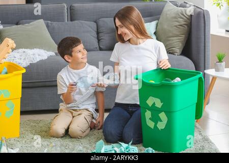 Family sorting garbage at home. Concept of recycling Stock Photo - Alamy