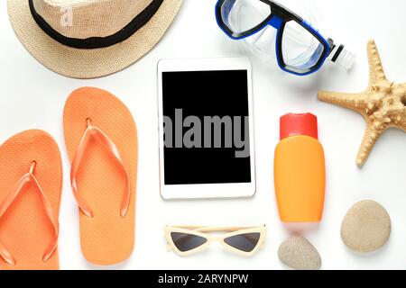 Flat lay composition with tablet and beach accessories on colored ...