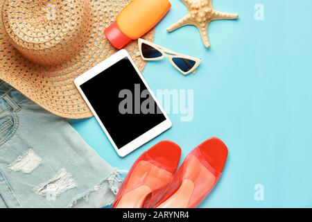 Flat lay composition with tablet and beach accessories on colored ...