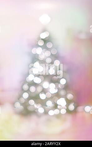 A vertical shot of illuminated Christmas lights wrapper around a tree ...