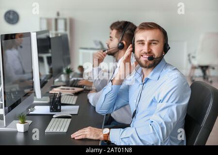 Technical support agents working in office Stock Photo - Alamy