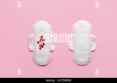 Menstrual pads with red beads on color background. Menstruation concept ...