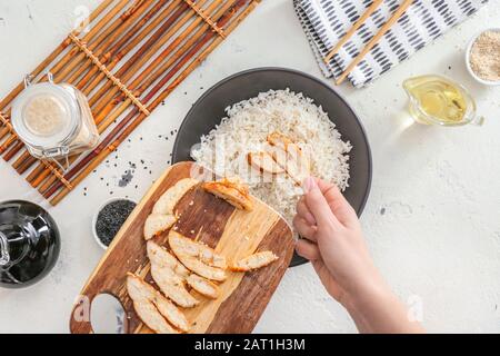 Woman preparing tasty rice with chicken Stock Photo - Alamy