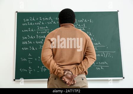 African-American math teacher near blackboard in classroom Stock Photo ...