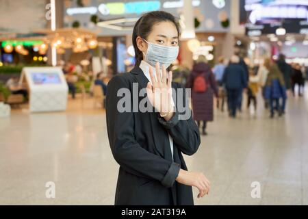 A girl wears face mask to help curb the spread of the coronavirus waves ...