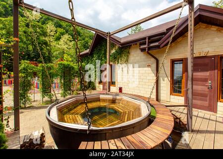 Bath tub on firewood, designed for bathing in hot water. The water is ...