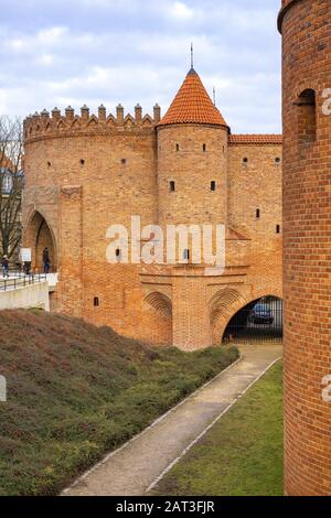 The historic defense walls of the Barbican in Warsaw's Old Town during ...