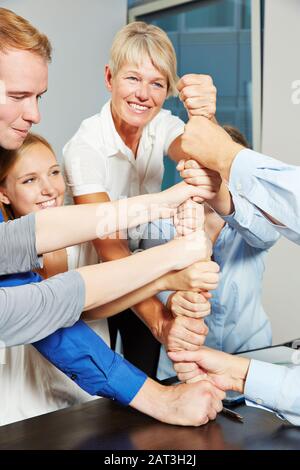 Business people, fist and stack in office for team building, inclusion ...