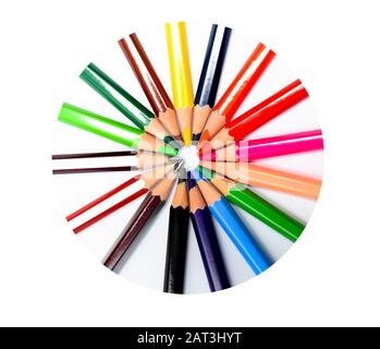 some pencil crayons of different colors on a notebook, with a frame and ...