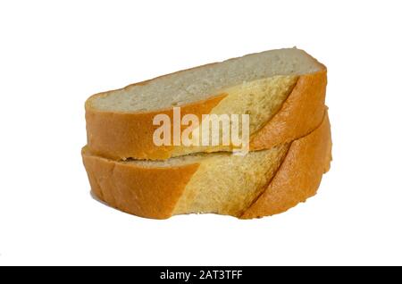 Two slices of white bread are side by side on a white plate; the first ...