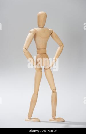 Wooden puppet with hinges on grey background Stock Photo - Alamy