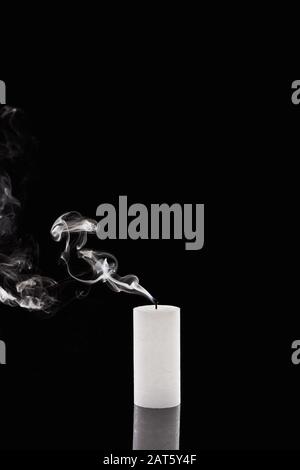 Extinct candle with smoke on a black background, symbol of death Stock ...