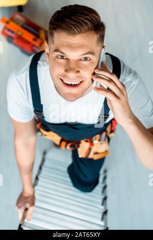 happy installer talking on smartphone and looking at camera Stock Photo ...