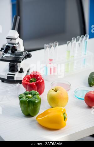 microscope, fruit, vegetables, test tubes on table in lab Stock Photo ...