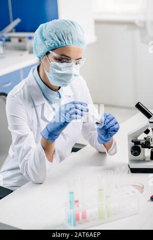 genetic consultant in white coat doing dna test in lab Stock Photo - Alamy