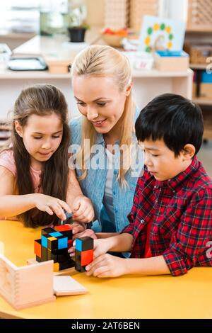 Boy playing with building blocks in classroom, elevated view Stock ...
