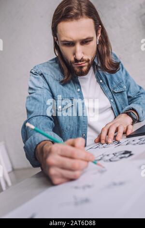 selective focus of illustrator drawing cartoon sketches Stock Photo - Alamy