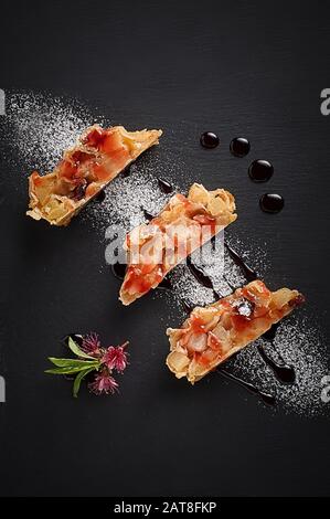 Overhead view of strudel cake on a wooden table outdoor. Bozen, Italy ...