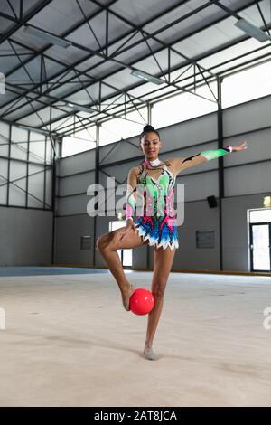 Woman, gymnastics and ball for flexible performance, body balance and ...