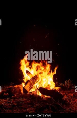 Campfire burning at dark night Stock Photo - Alamy