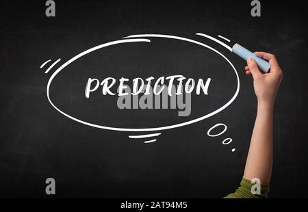 Hand drawing PREDICTION inscription with white chalk on blackboard ...