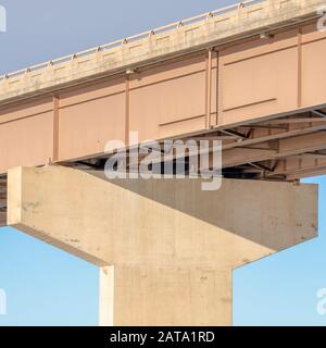 View beneath a stringer bridge with massive abutment that supports the ...