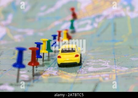View of a Car on a map with a pin holder - GPS and localization concept ...