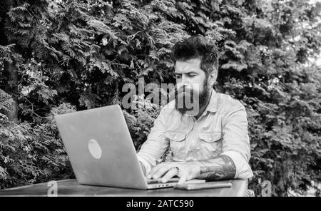 Doing a blog on free wifi. an attractive young woman using a digital ...