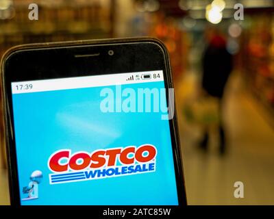 In this photo illustration a Costco Wholesale logo seen displayed on a ...
