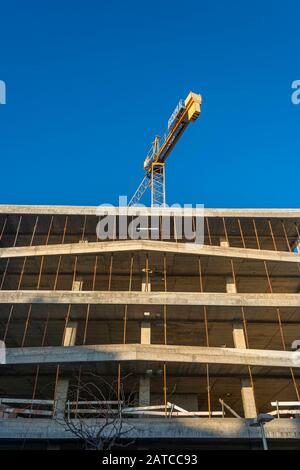 Construction site where flats are being built with scaffolding on which ...