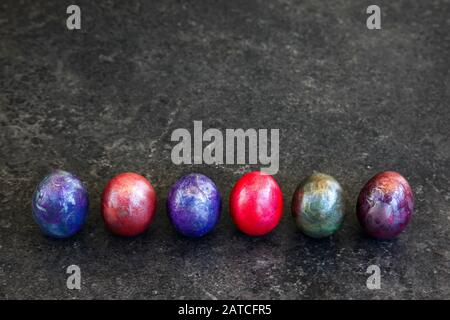 Colored Easter eggs on a dark background. Christian Easter Stock Photo ...