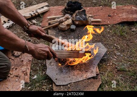 How to start a fire the traditional way: a man demonstrates ancient ...