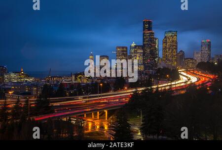 Seattle skyline at sunrise during rush hour traffic with light trails ...